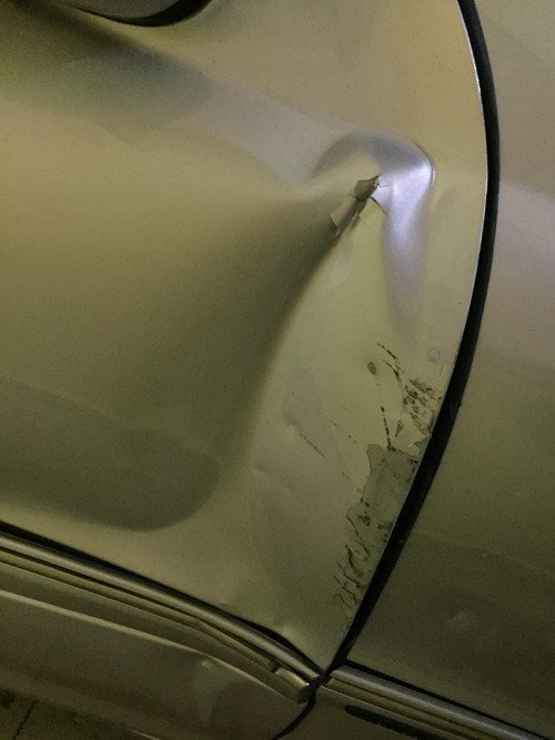 Opened car door hit by other n won’t close now